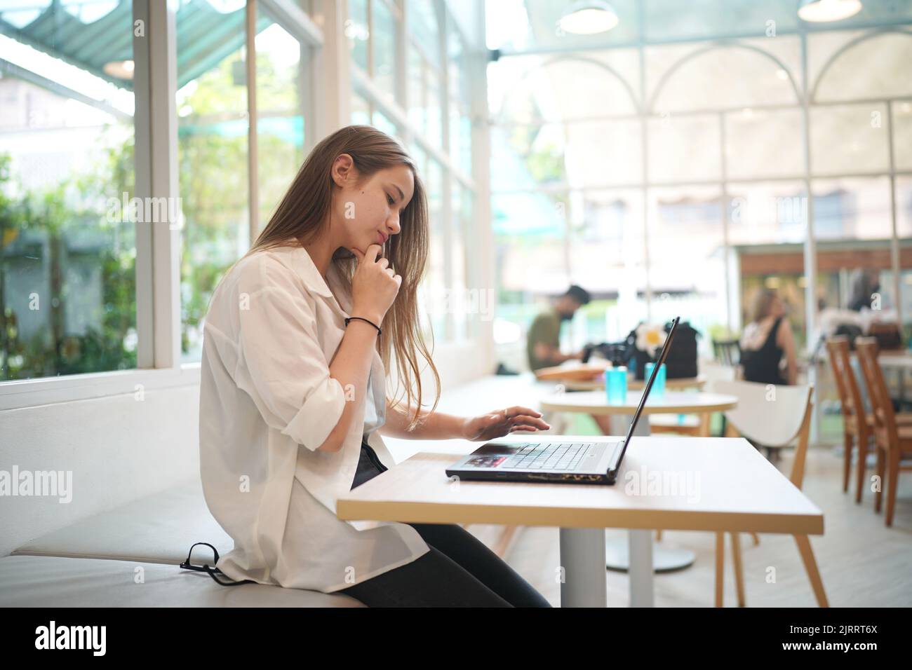 Technology and people concept, young woman using laptop and internet ...