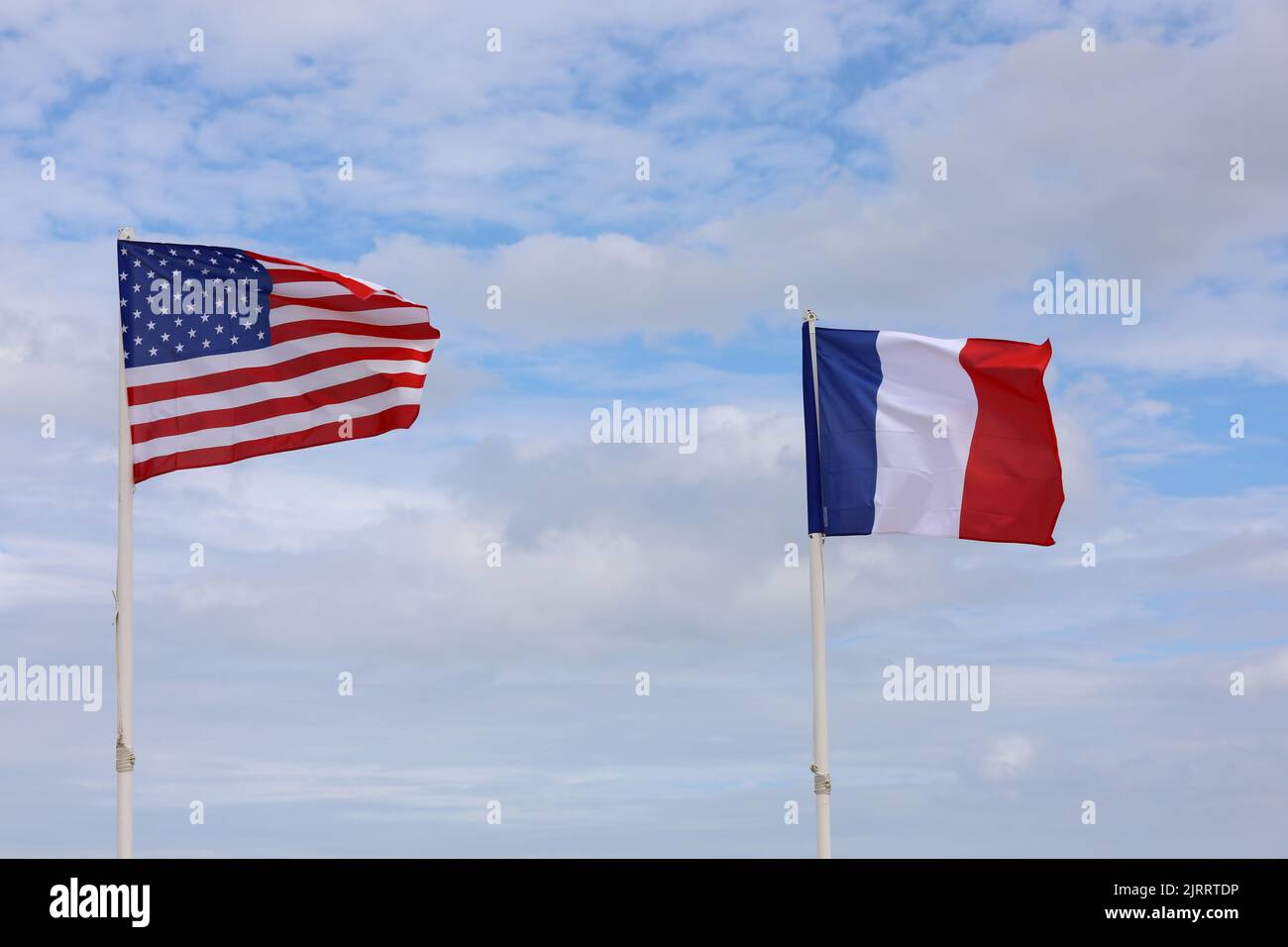 Large waving flags of the United States of America and France on a sky ...