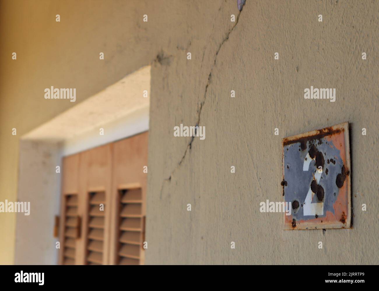 An abandoned unoccupied house with a crack on the concrete wall Stock ...