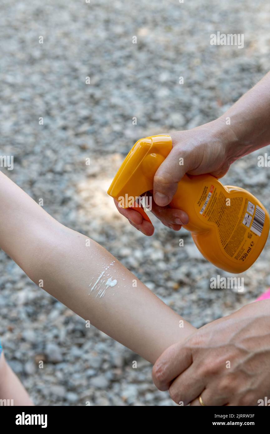 Child apply sunscreen hi-res stock photography and images - Alamy