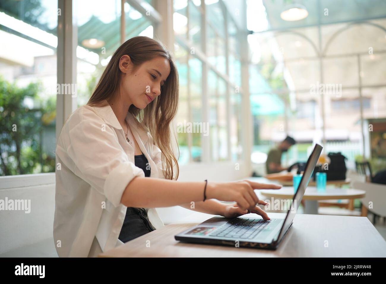 Technology and people concept, young woman using laptop and internet ...