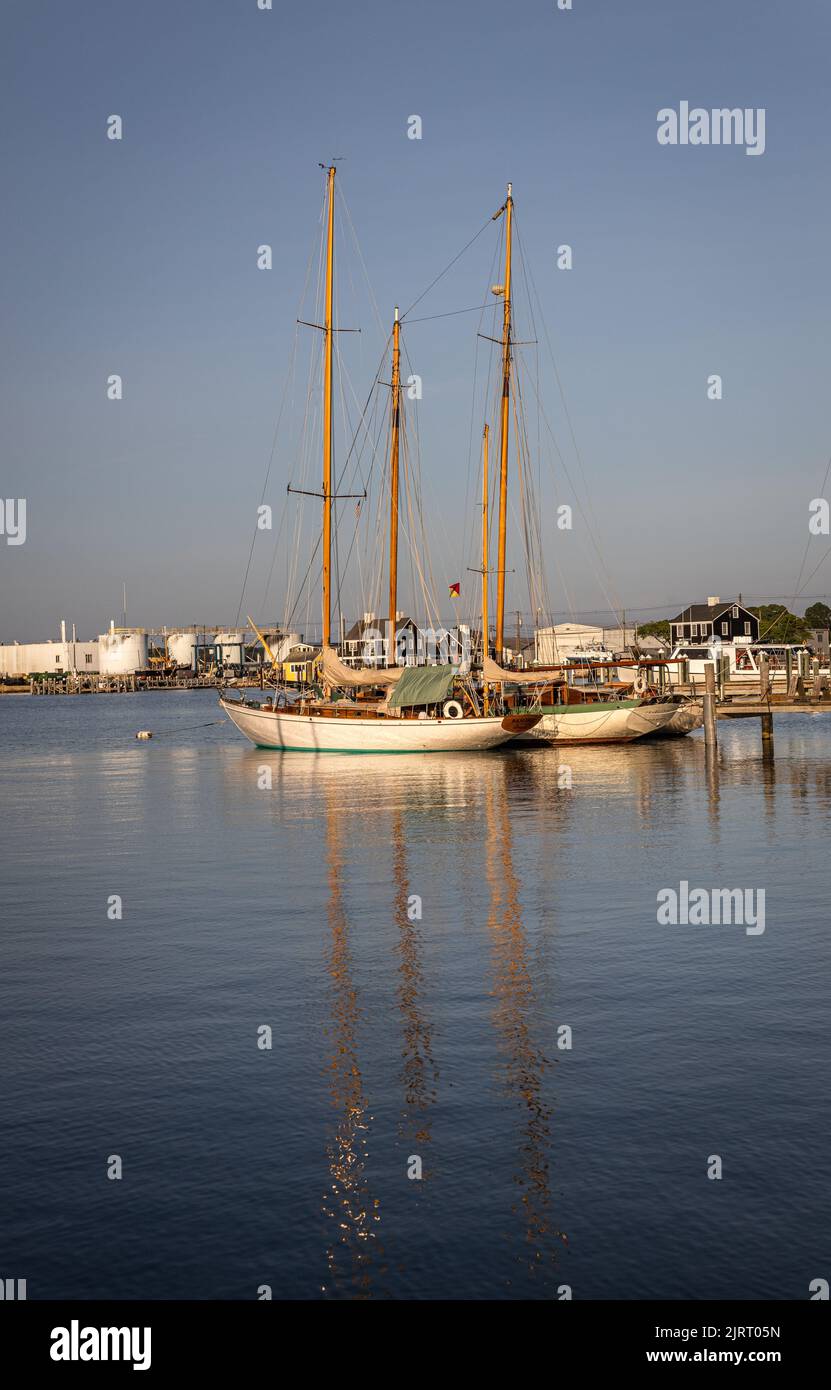 A vertical shot of white boats at a dock during sunset Stock Photo - Alamy
