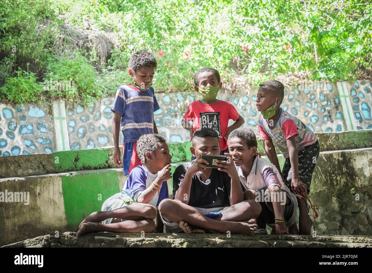 Some Papuan children play while wearing masks to prevent transmission ...