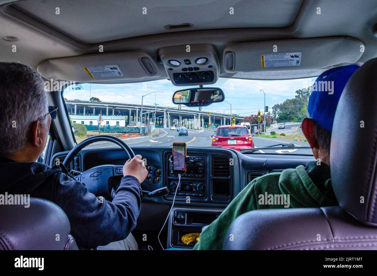 Rear passenger view in a car travelling along a road in America Stock ...