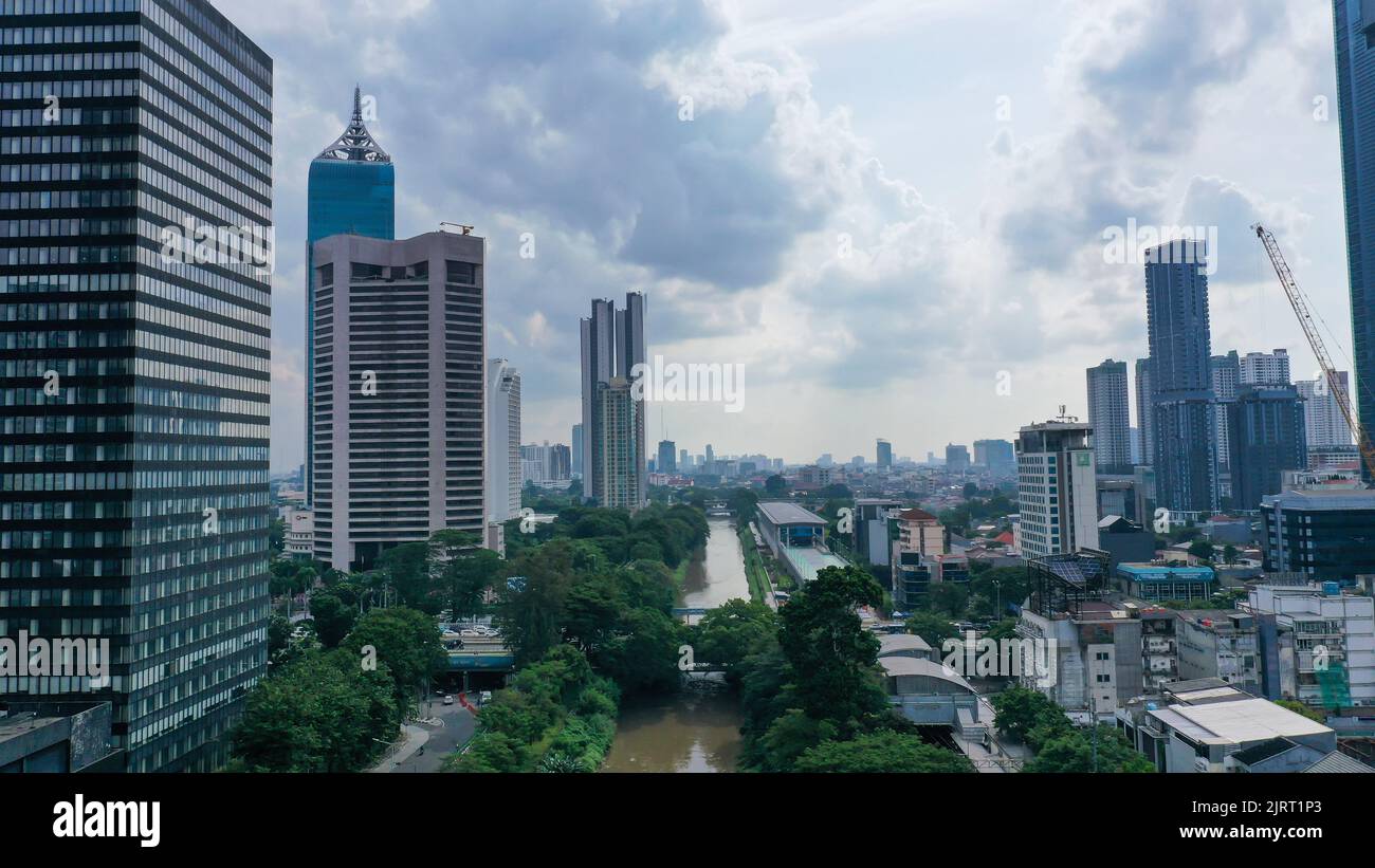 Aerial view of Jakarta city with urban buildings and river at morning ...