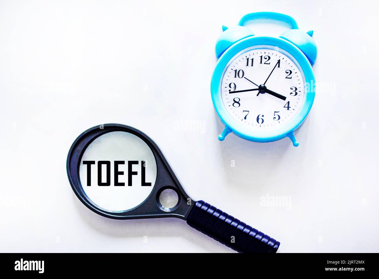 TOEFL is a test of English as a foreign language. text on a magnifying ...