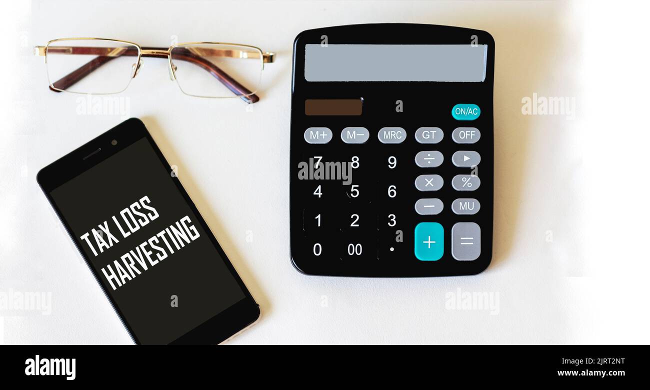 Business concept. On a white surface, a calculator, a mobile phone with ...
