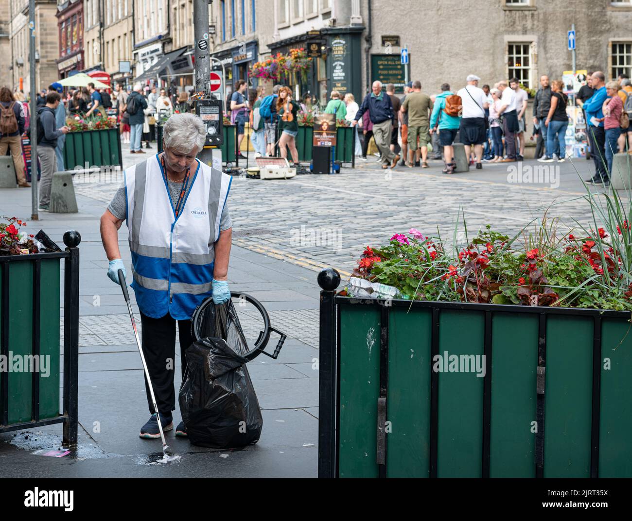 Litter Picker at work during the Edinburgh Fringe Festival and a ...
