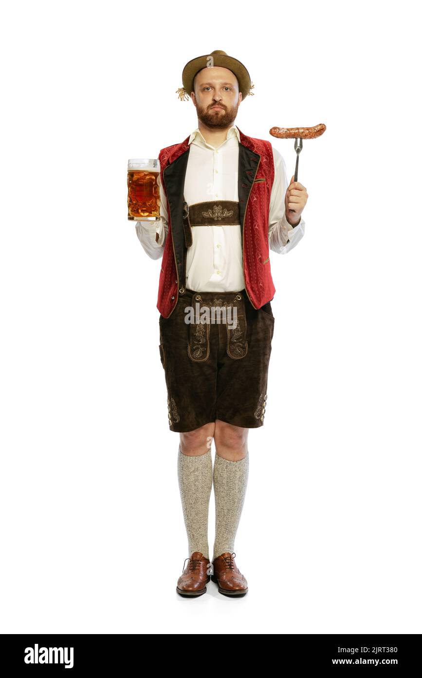 Full-length portrait of young man wearing traditional Bavarian or ...