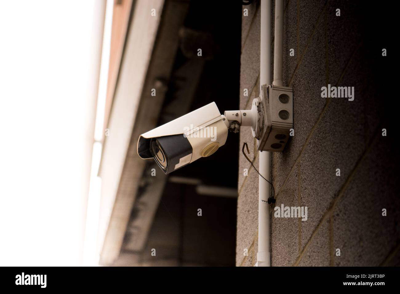 Close up of facade garage entrance with mounted surveillance camera ccd ...