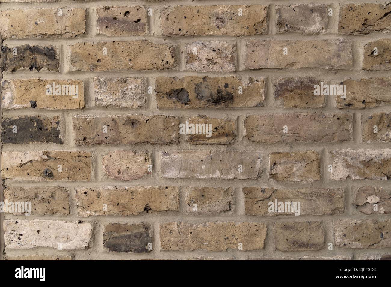 Close up several colored exactly bricked laid brick wall as background ...