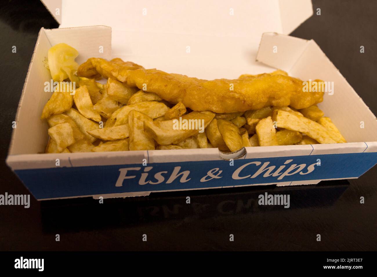 Close up of fast food cardboard box filled with fish and chips to take ...