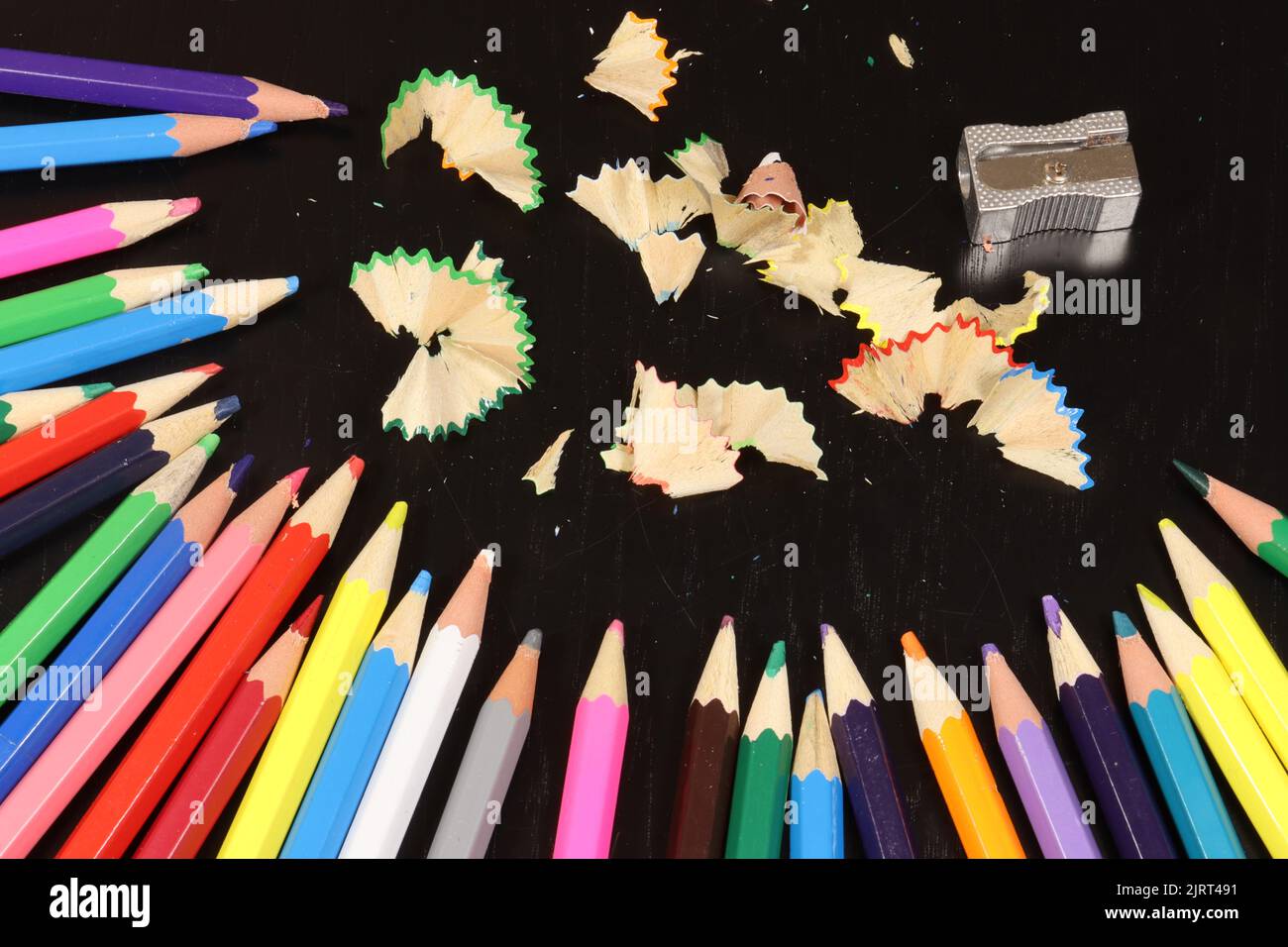 Colored pencil over a black wood table Stock Photo - Alamy