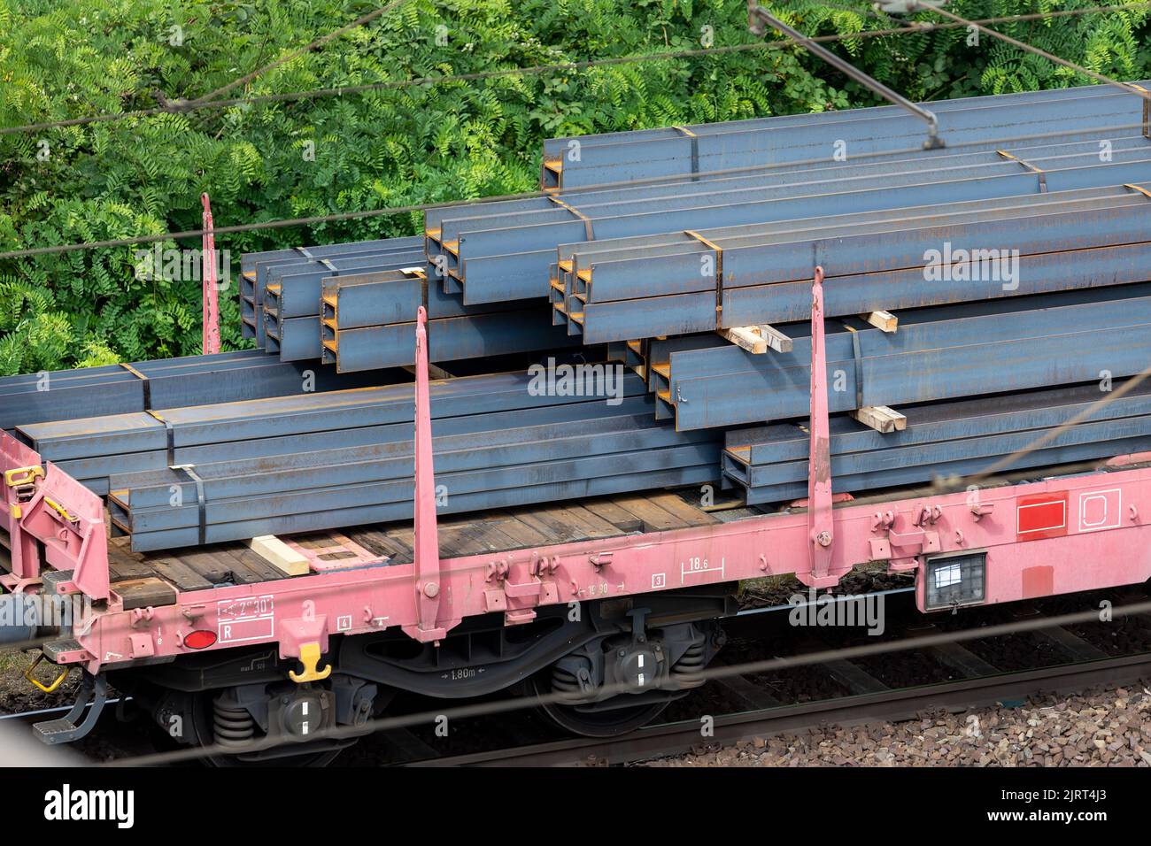 Heap pile heavy raw rusted steel iron beam girders loaded on railroad ...