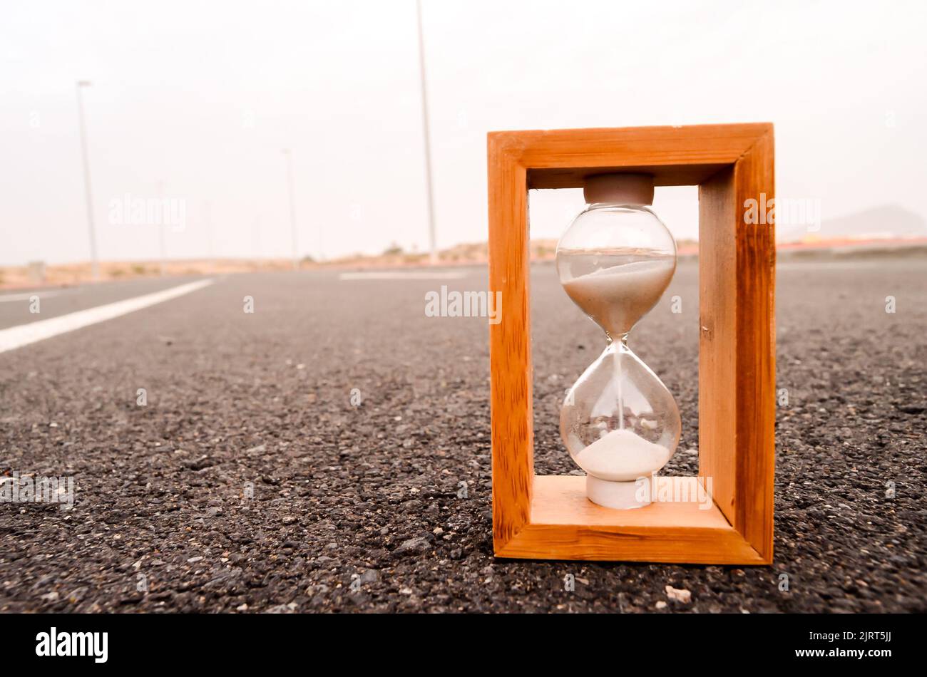 Time Concept Alarm Hourglass on the Asphalt Street Stock Photo - Alamy