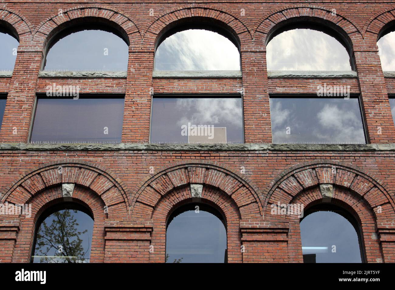 A brick facade with arch windows of an old historical building Stock ...