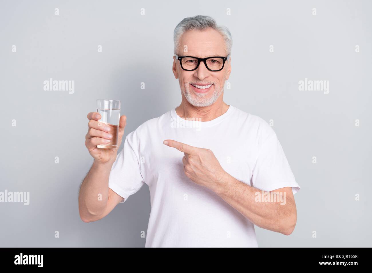 Photo of positive friendly person indicate finger demonstrate water ...