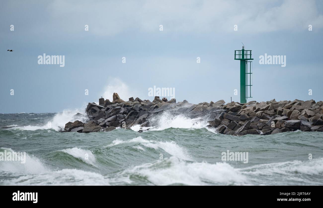 A storm in the Baltic Sea. Rough sea in the background a concrete ...