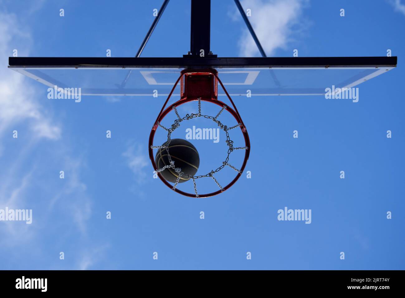 Street basketball ball falling into the hoop. Urban youth game. Concept ...