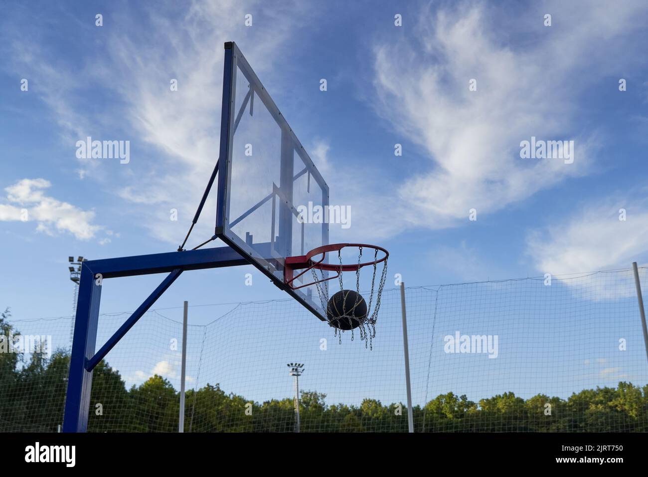 Street basketball ball falling into the hoop. Concept of success ...