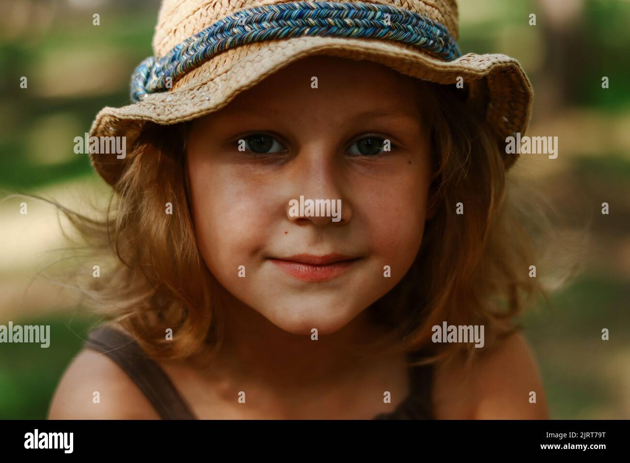 Cute blonde child 5 years old. Child in a straw hat. Portrait of a baby ...
