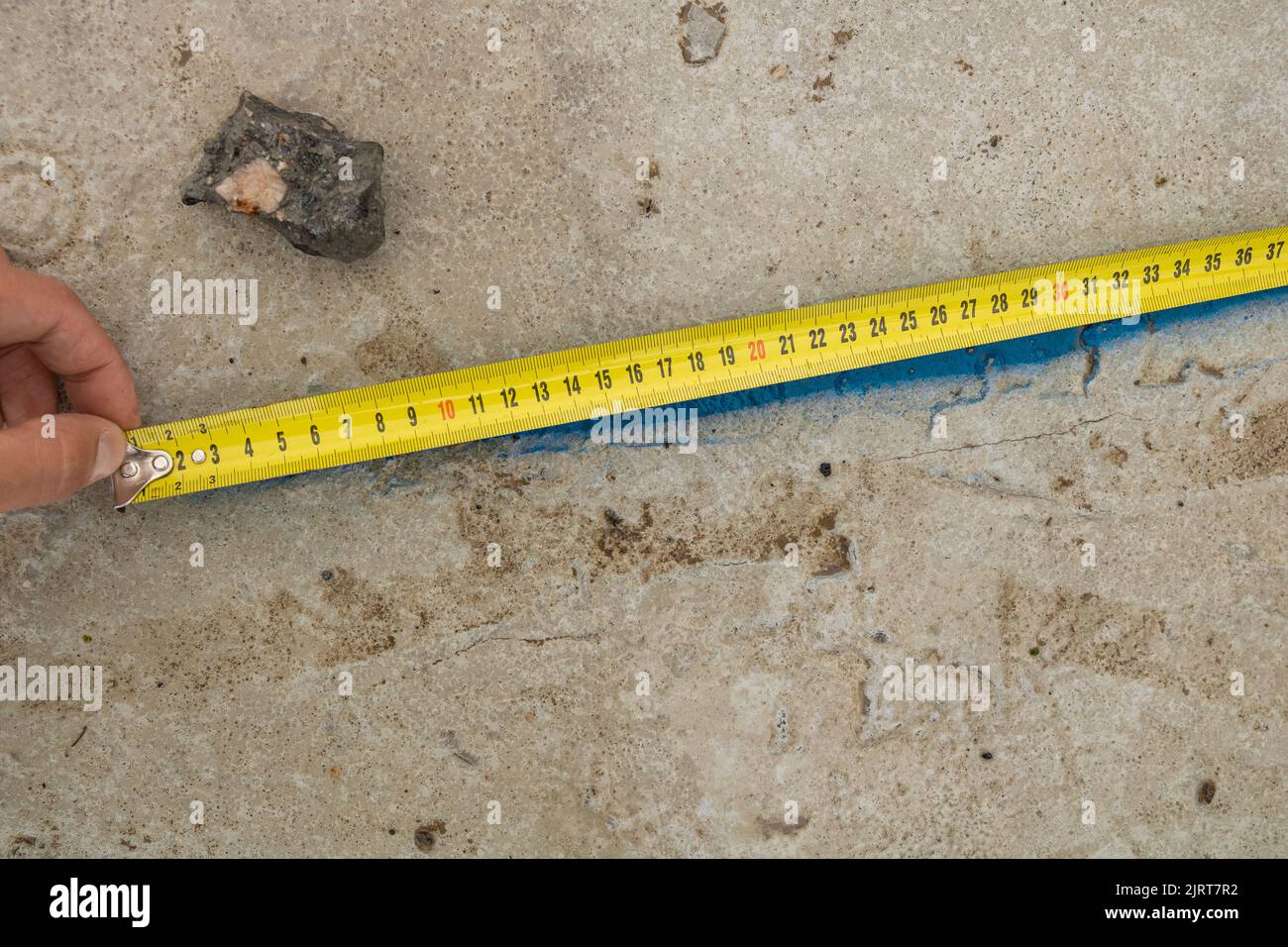 Measuring ruler on a concrete wall texture. The concept of renovation ...