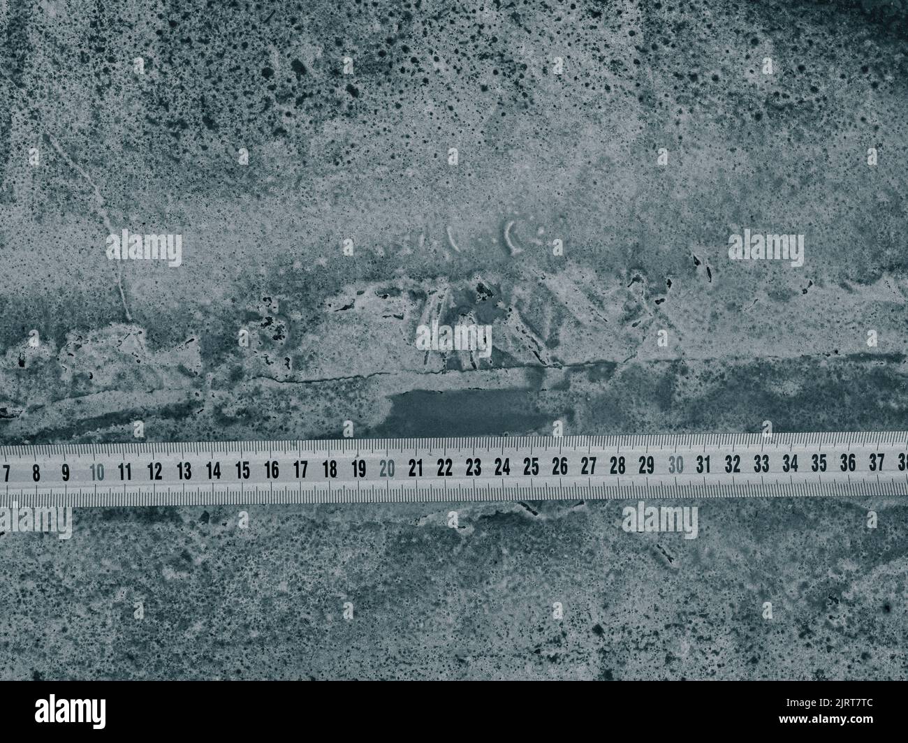 Measuring ruler on a concrete wall texture. The concept of renovation ...