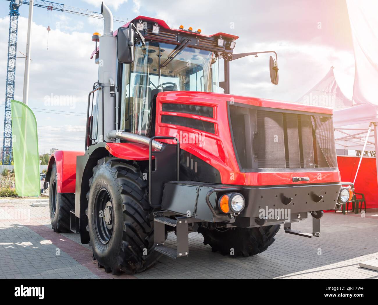 Red heavy duty wheeled tractor on a parking lot Stock Photo - Alamy