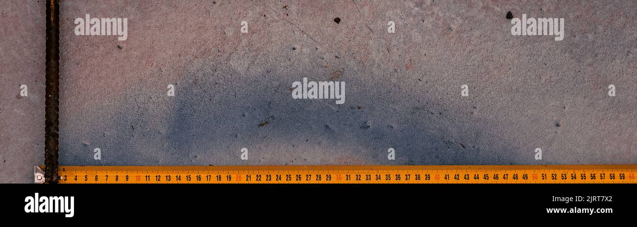 Measuring ruler on a concrete wall texture. The concept of renovation ...