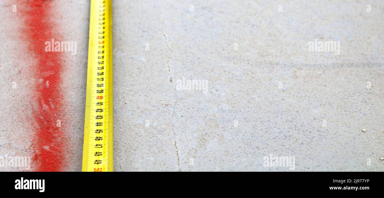 Measuring ruler on a concrete wall texture. The concept of renovation ...