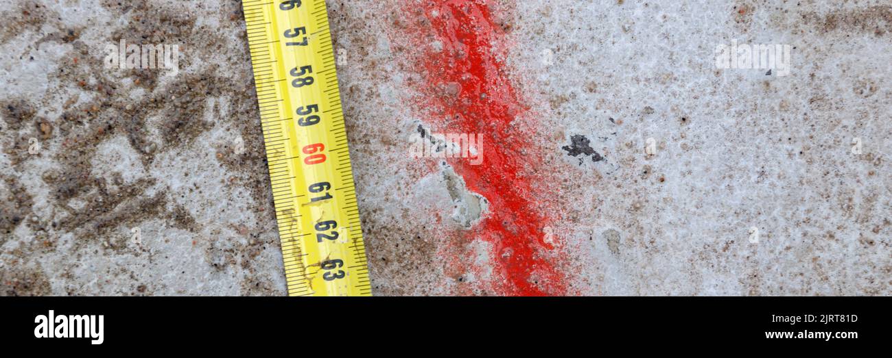 Measuring ruler on a concrete wall texture. The concept of renovation ...