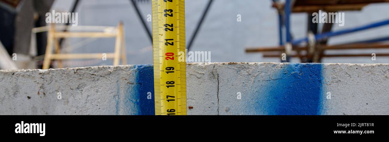 Measuring ruler on a concrete wall texture. The concept of renovation ...