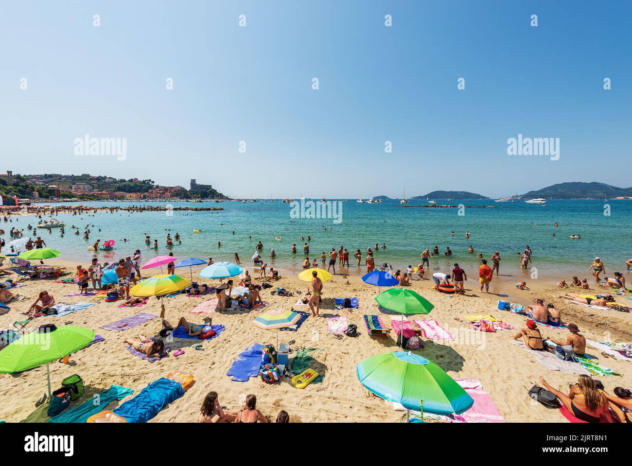 Beach of Lerici town with many umbrellas, tourist resort on the coast ...