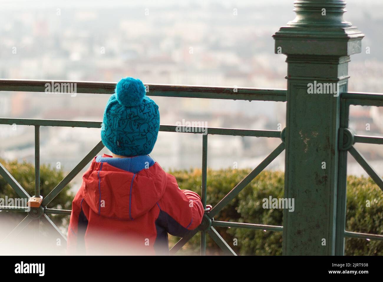 Alone little boy on the prospect viewpoint looking into the distance ...