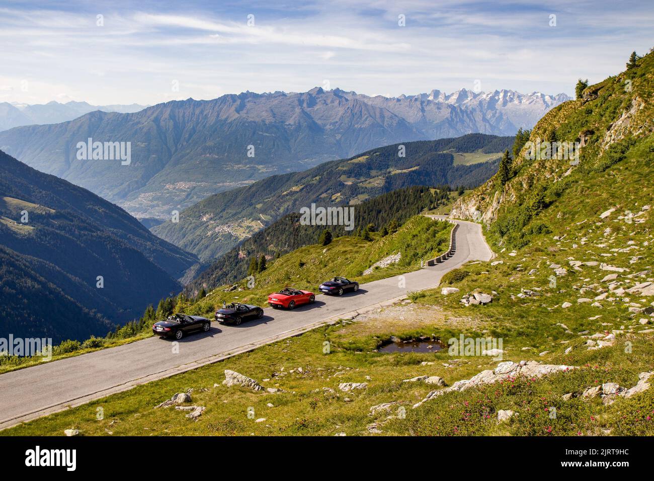 San Marco Pass, Italy - June 17, 2022. Four roadsters on beautiful ...