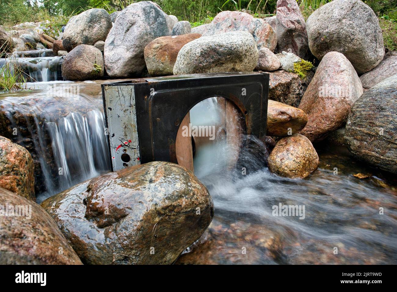 Small metallic water wheel in the stream Stock Photo - Alamy