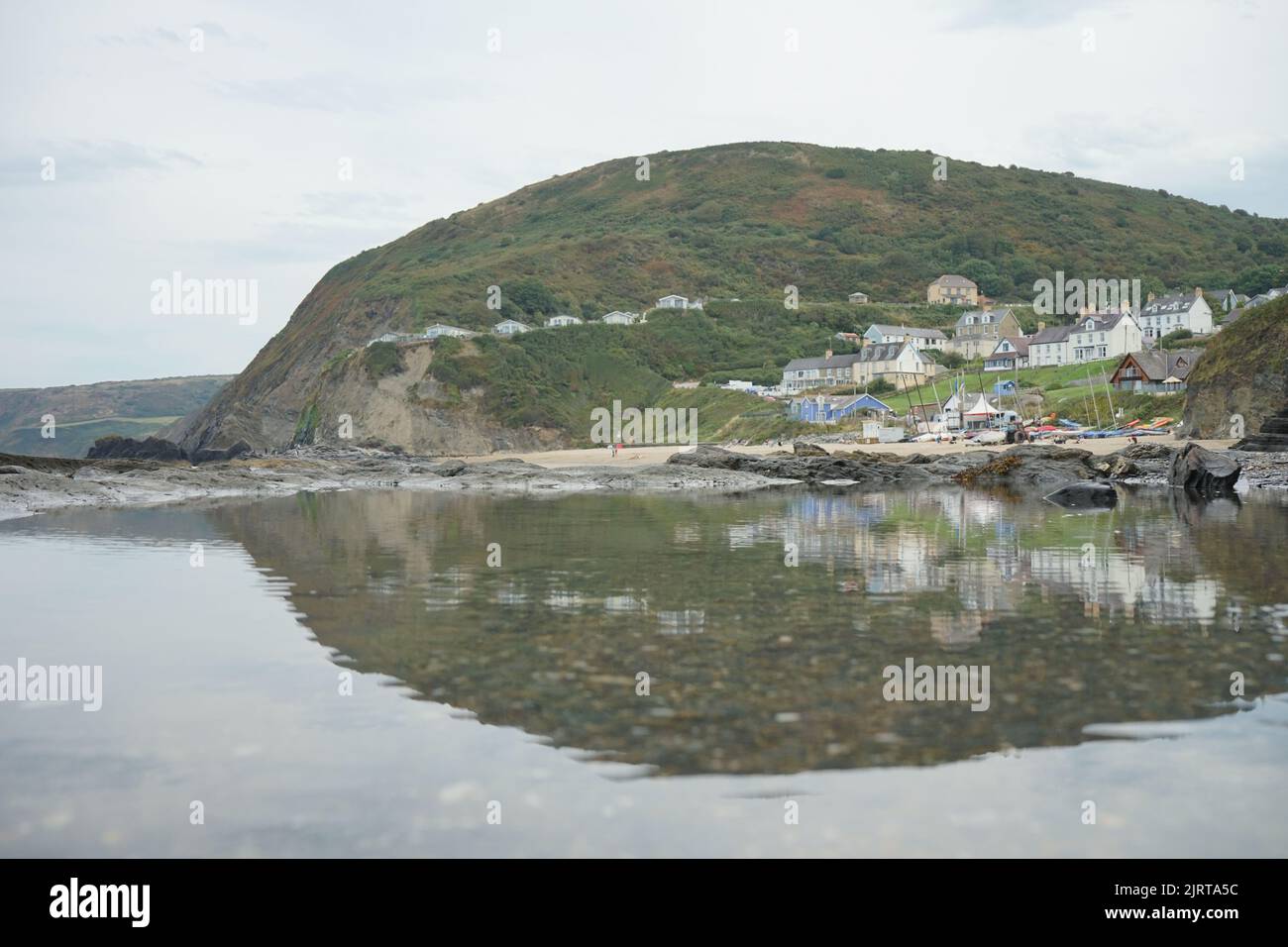 The welsh village of Tresaith reflected in a rock pool Stock Photo - Alamy