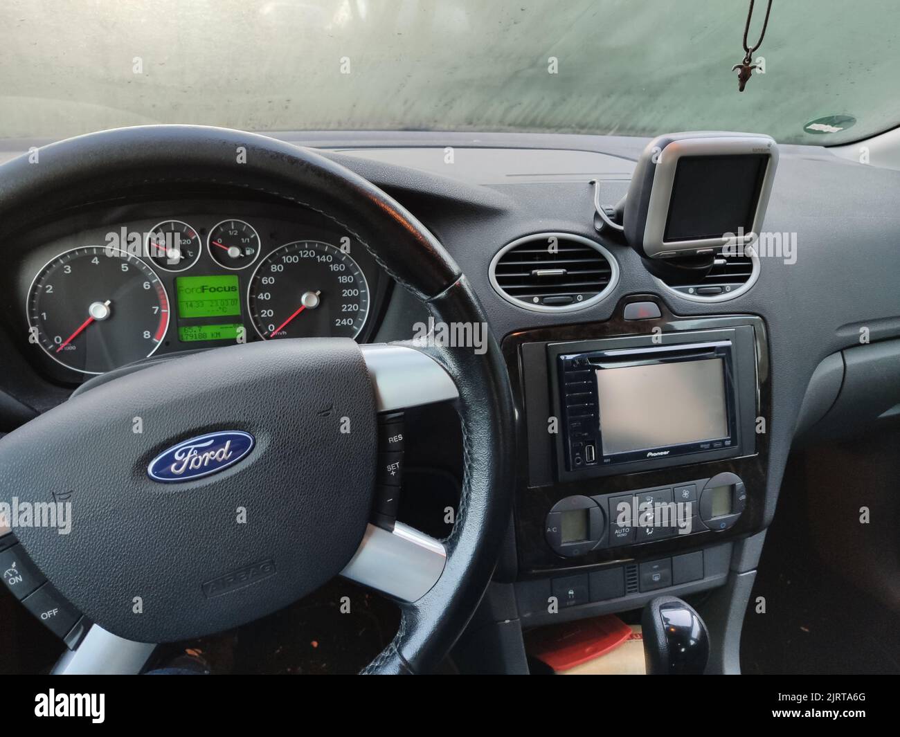 A cockpit with a steering wheel, speedometer and radio in Ford Focus ...
