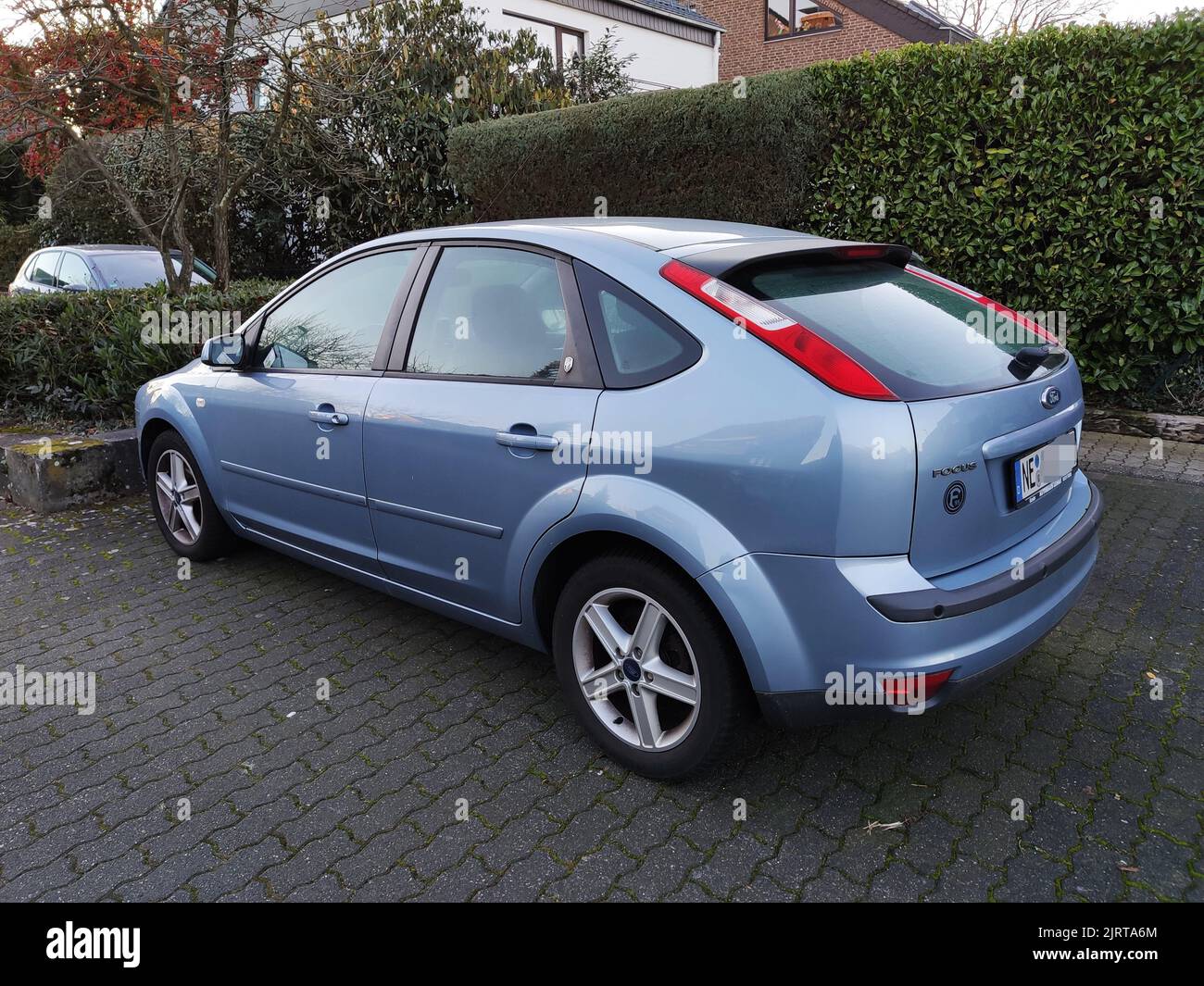 A rear view of a blue Ford Focus MK2 car from 2005 parked in the street ...