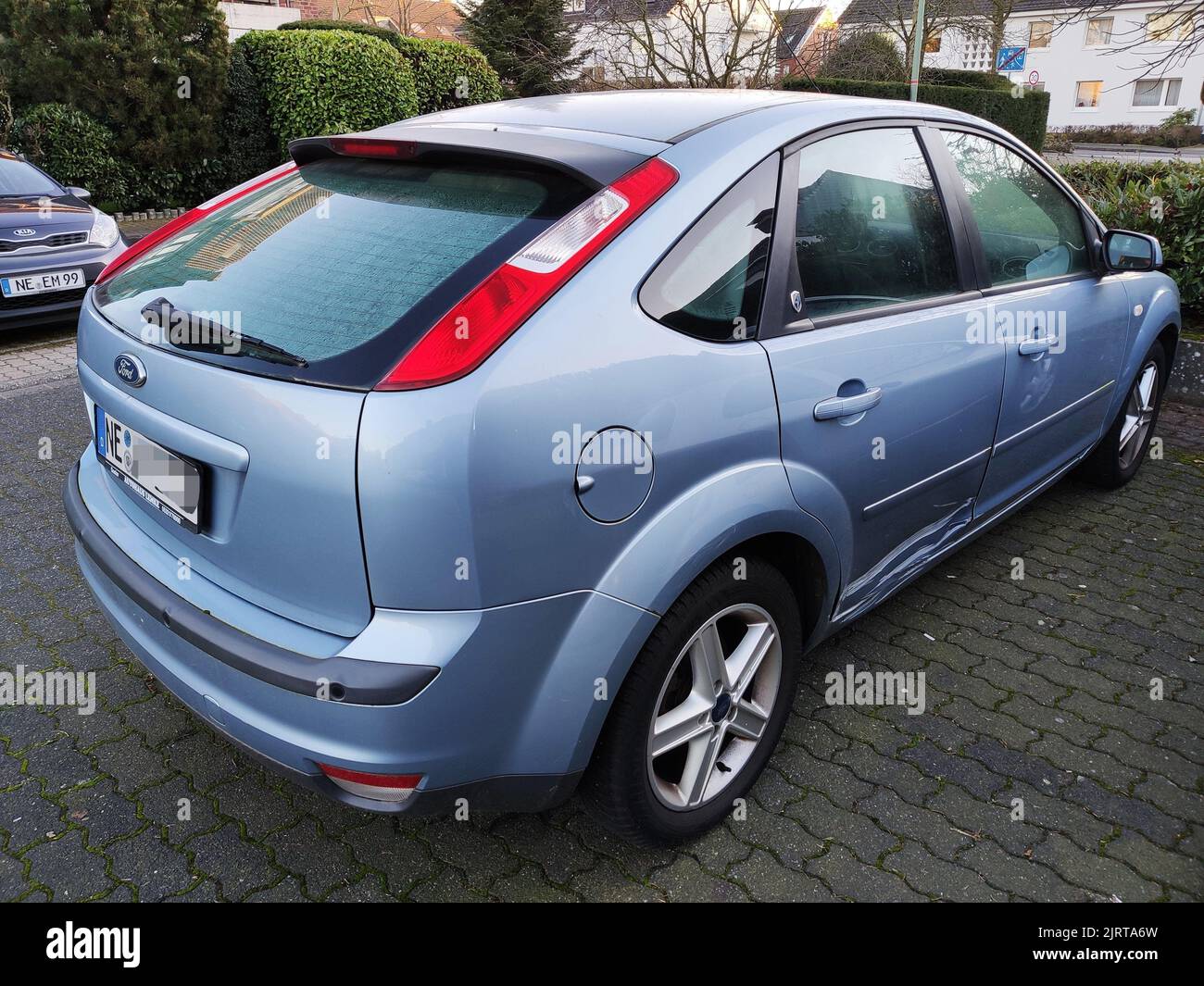 A rear view of a blue Ford Focus MK2 car from 2005 parked in the street ...