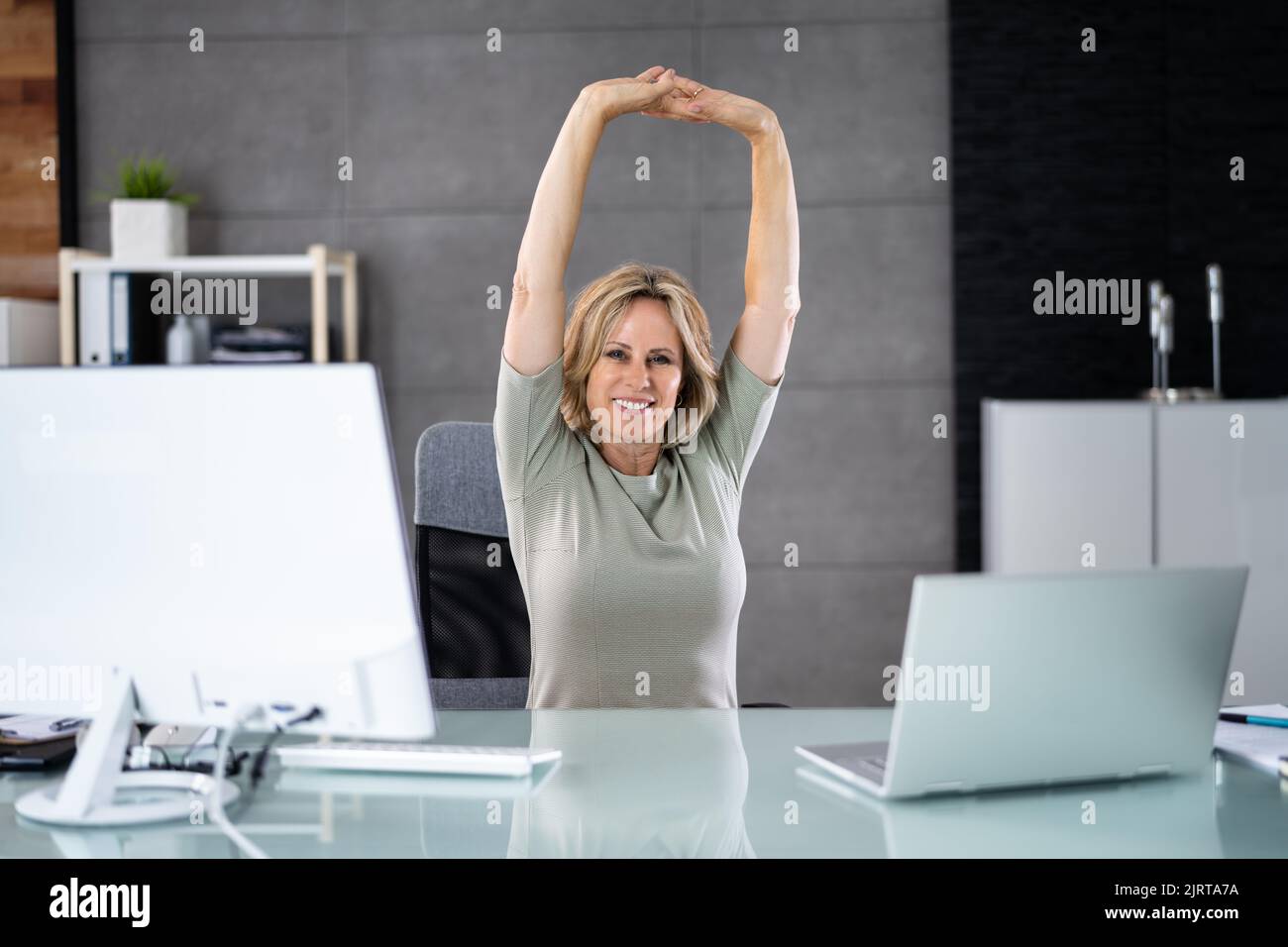 Stretch Exercise Workout At Office Business Desk Stock Photo - Alamy