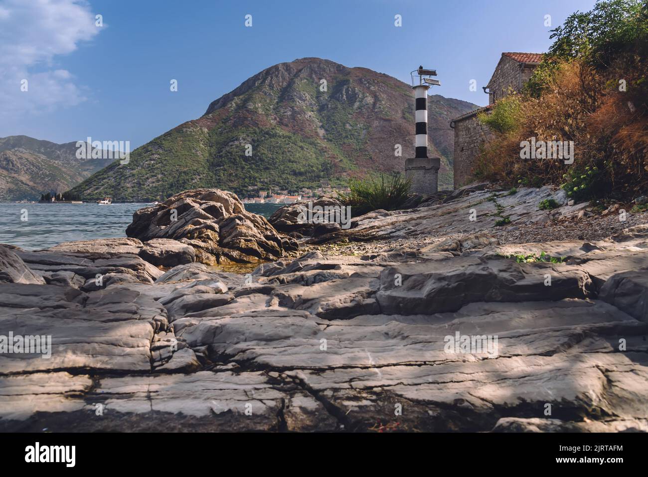 Lighthouse and Gospa od Andjela Church in Montenegro Stock Photo - Alamy
