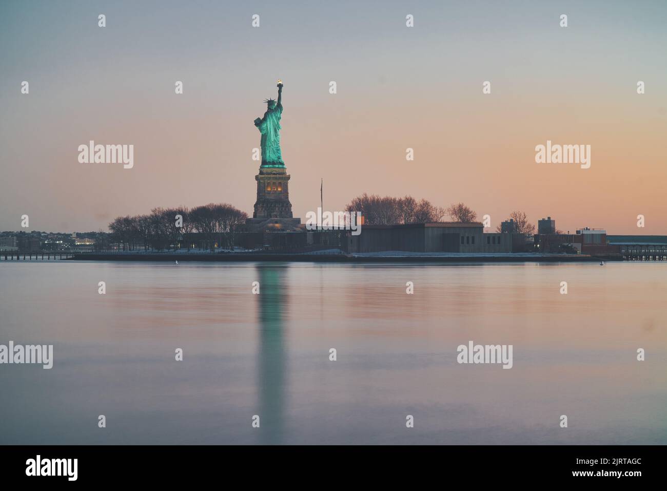 A view of a statue of Liberty and its reflection in the water in Jersey ...