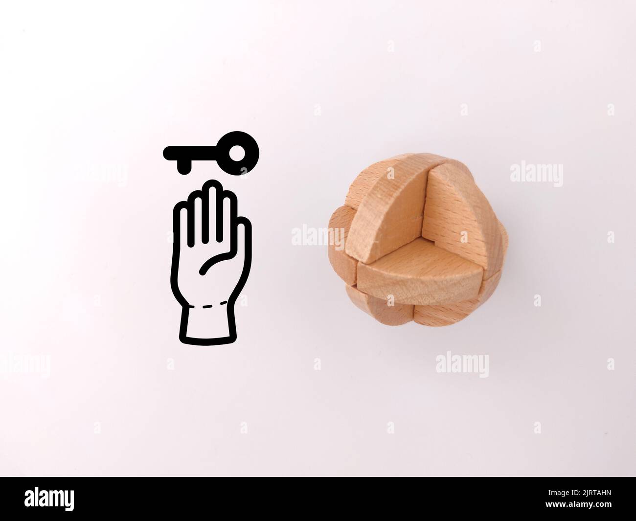 A wooden brain teaser puzzle with a key icon on a white background ...
