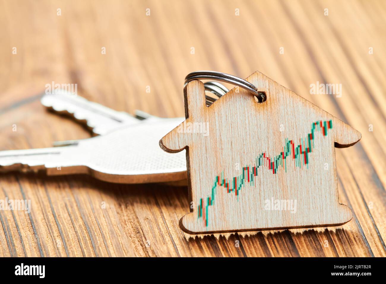 Trinket in the form of a wooden house with the keys to the apartment on ...