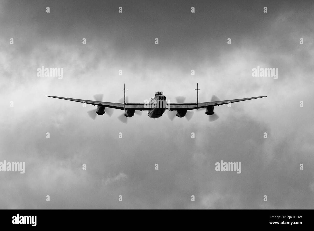 An Avro Lancaster flying into a stormy sky Stock Photo - Alamy