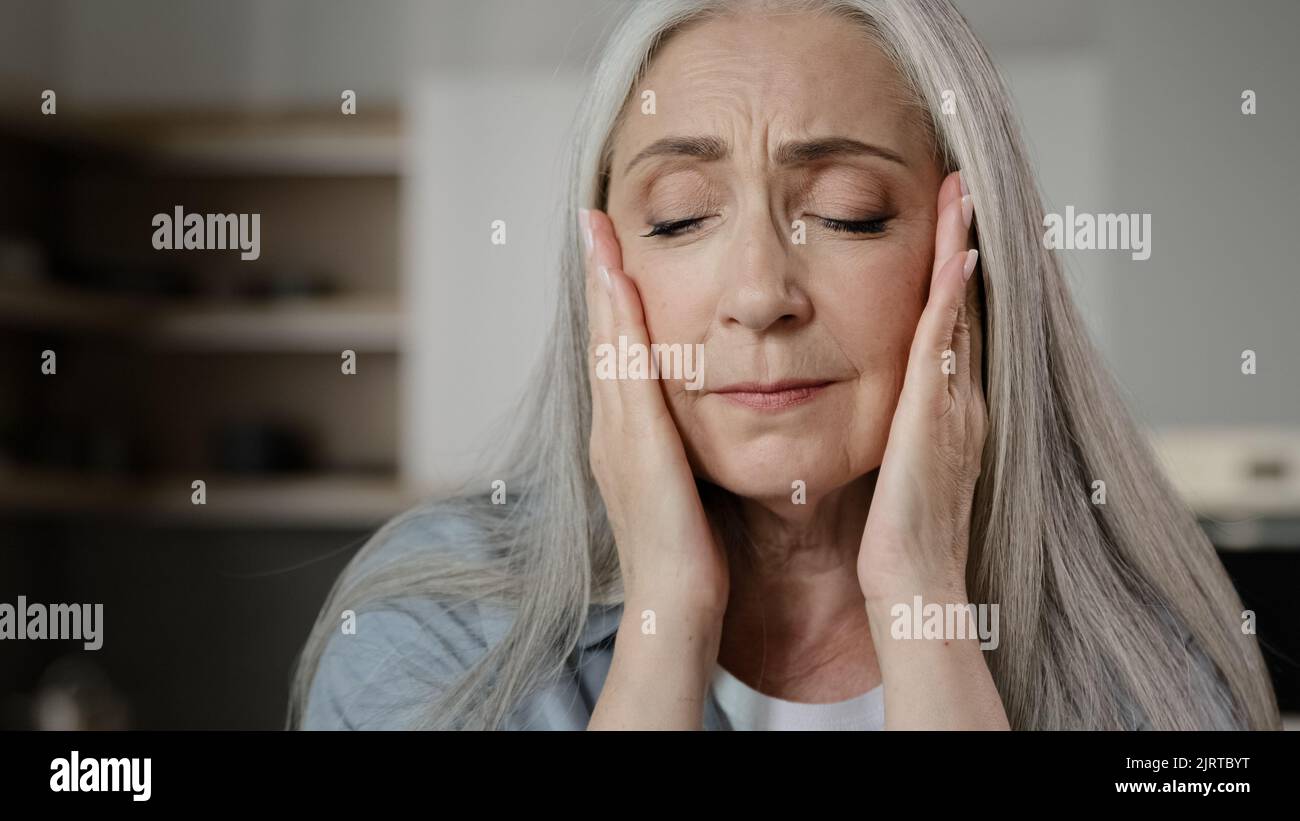 Sick old mature caucasian woman worried tired upset retiree grey-haired ...