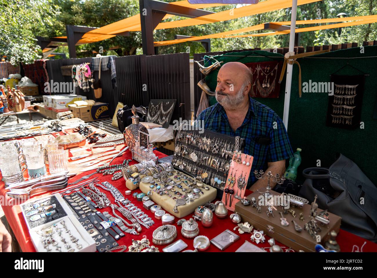 Man with mustache sells vintage jewelry on the flea market in Georgia ...