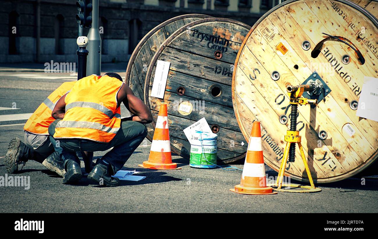 Two men working in the street in France Stock Photo - Alamy