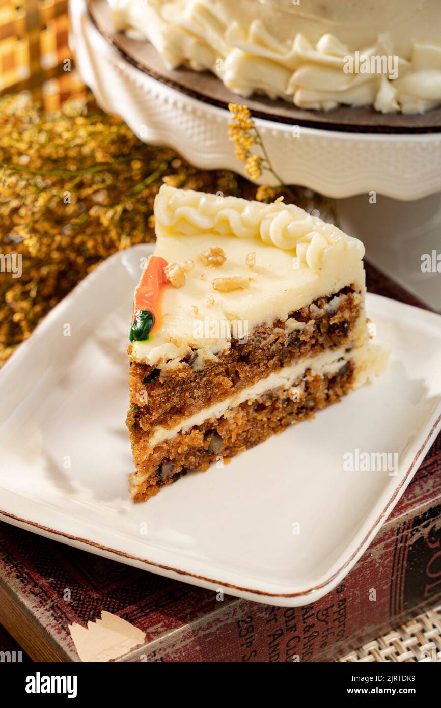 A vertical shot of a carrot cake piece on a white plate Stock Photo - Alamy